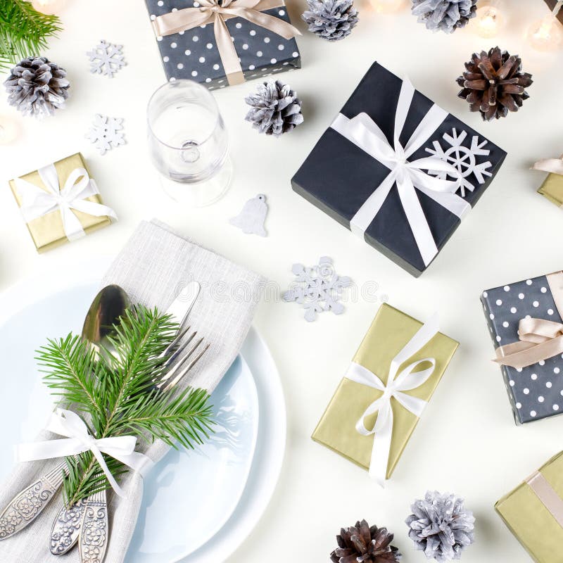 Christmas Table Setting with Plates, Silverware, Presents, Candles and ...