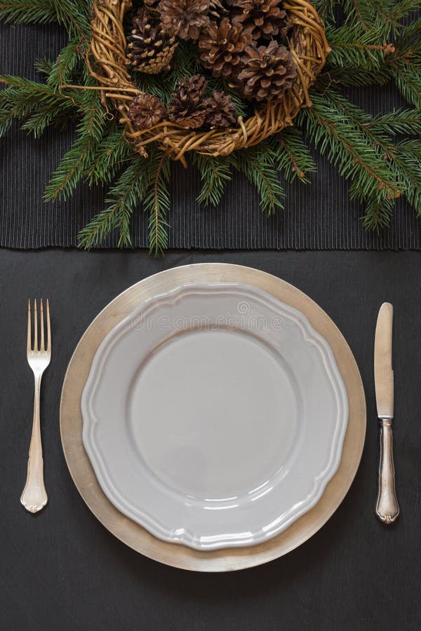 Christmas Table Setting with Silverware and Dark Evergreen Decor. Top ...