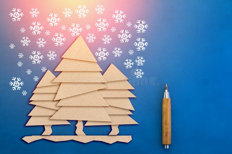 Christmas Tree Cut Out from Paper and Doodle Snow Flake on Blue Stock ...
