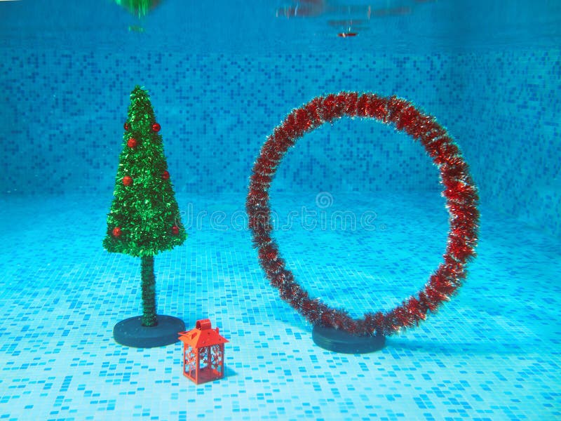 Christmas Tree and Decorations Underwater in the Swimming Pool. Stock ...