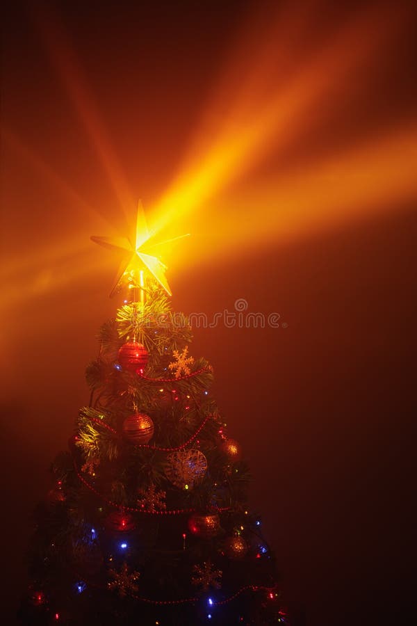 Christmas Tree with Festive Lights, Orange Background with Mist Stock ...