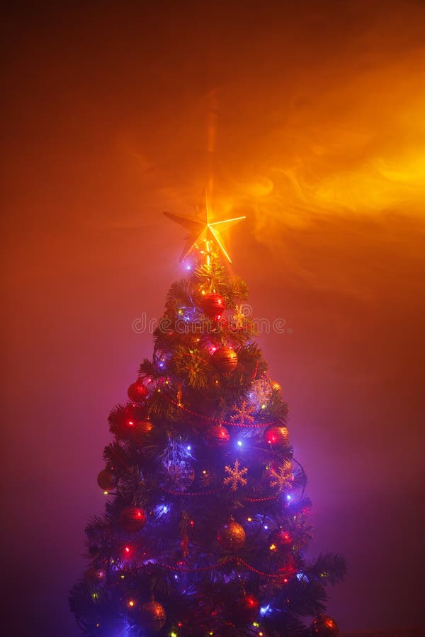 Christmas Tree with Festive Lights, Orange Background with Smoke Stock ...