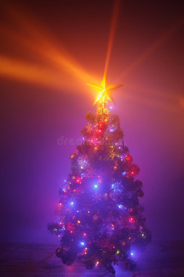 Christmas Tree with Festive Lights, Purple Background with Mist Stock ...