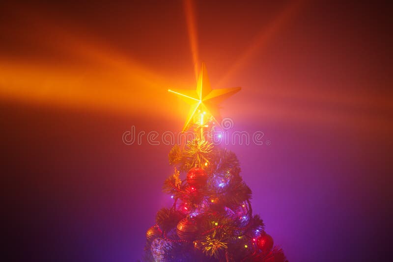 Christmas Tree with Festive Lights, Purple Background with Mist Stock ...