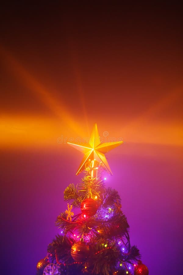 Christmas Tree with Festive Lights, Purple Background with Mist Stock ...