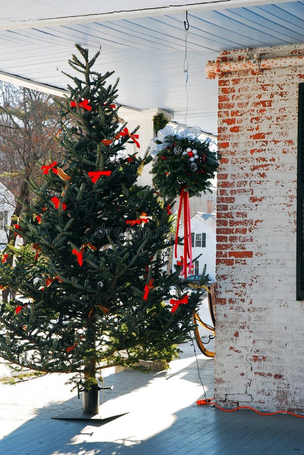 A Christmas Tree Stands on the Porch of a Pub Stock Photo - Image of ...