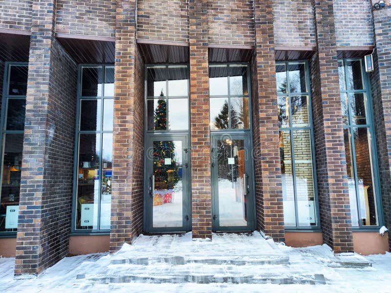 Christmas Tree through Window of Snow Covered Storefront with Brick ...