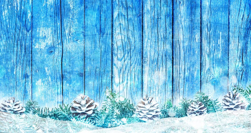 Christmas Trees and Cones Background on Blue Wooden Board and Snow ...