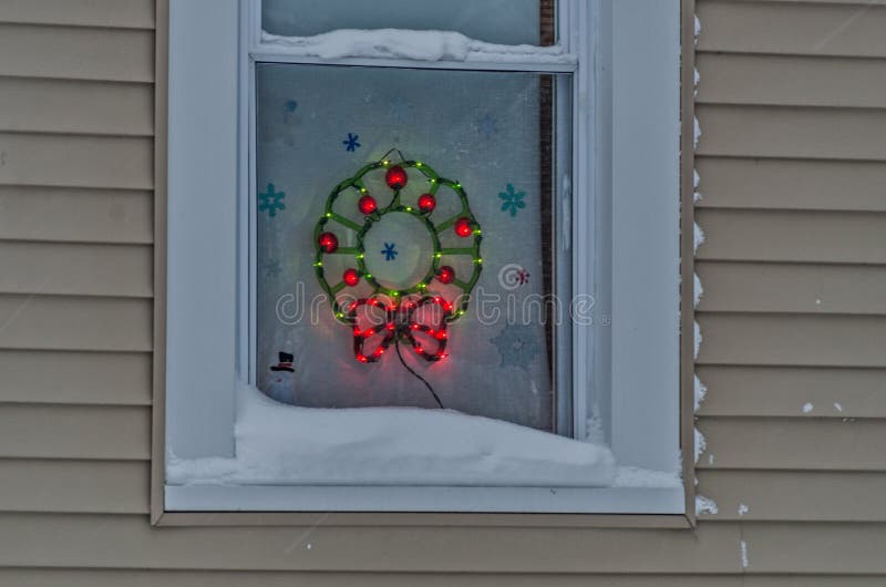Christmas Wreath Made of Lights in a Window with Snow Stock Photo ...