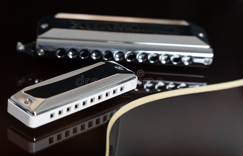 Chromatic and Diatonic Harmonica on the Back of Acoustic Guitar Stock ...