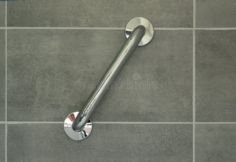 A Chrome Grab Handle in the Shower of a Grey Tiled Bathroom Stock Image ...