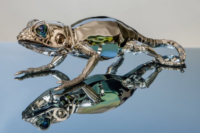 Chrome Lizard Sculpture Reflecting on Glass Surface Stock Image - Image ...