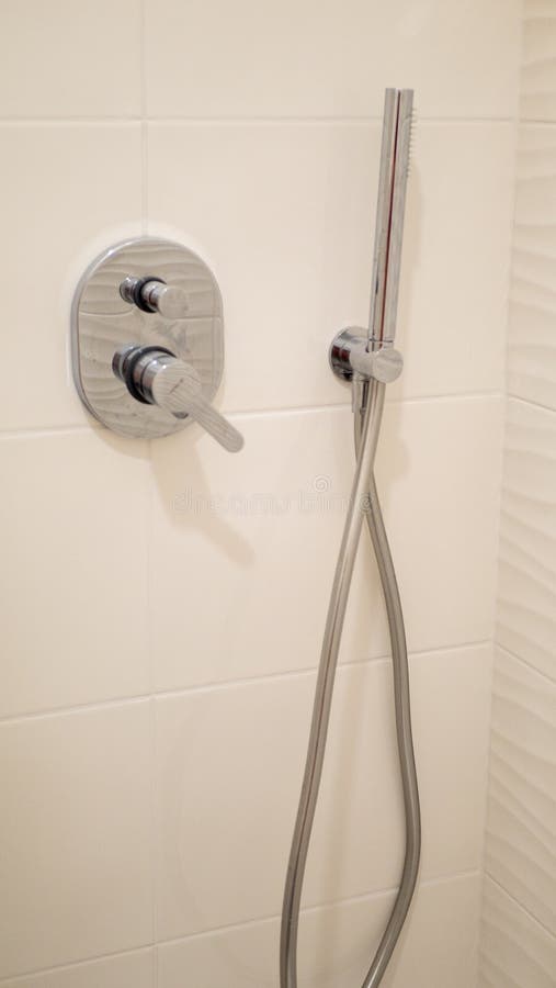 Chrome Tap and Shower in Bathroom. Tap on Bathroom Wall with Tiles ...