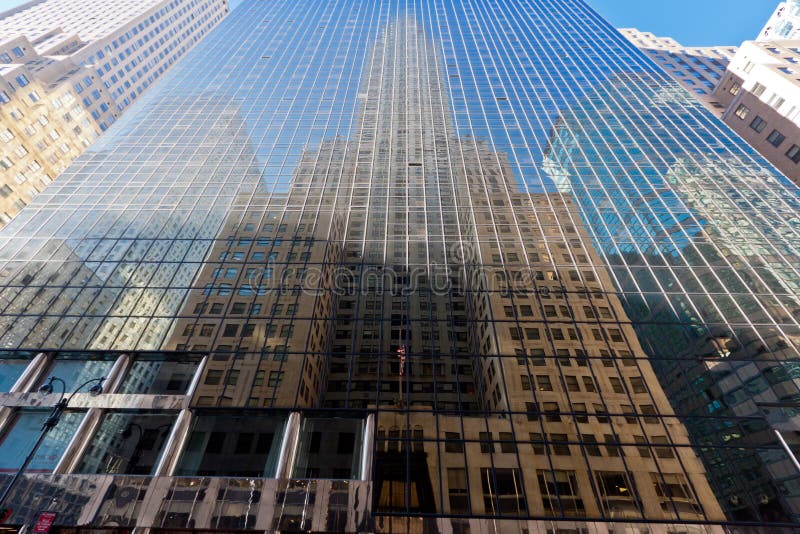 The Skyscraper is Reflected in the Windows of the Facade of a Modern ...