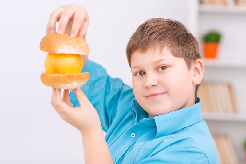 Chubby Kid with Buns and Orange Stock Photo - Image of chubby, domestic ...