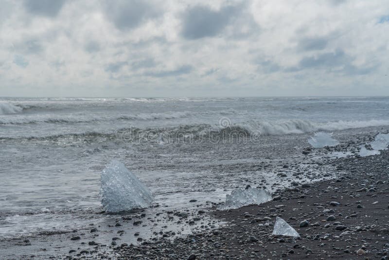 Chunks of Ice of Broken Icebergs on a Volcanic Black Sand Beach at ...