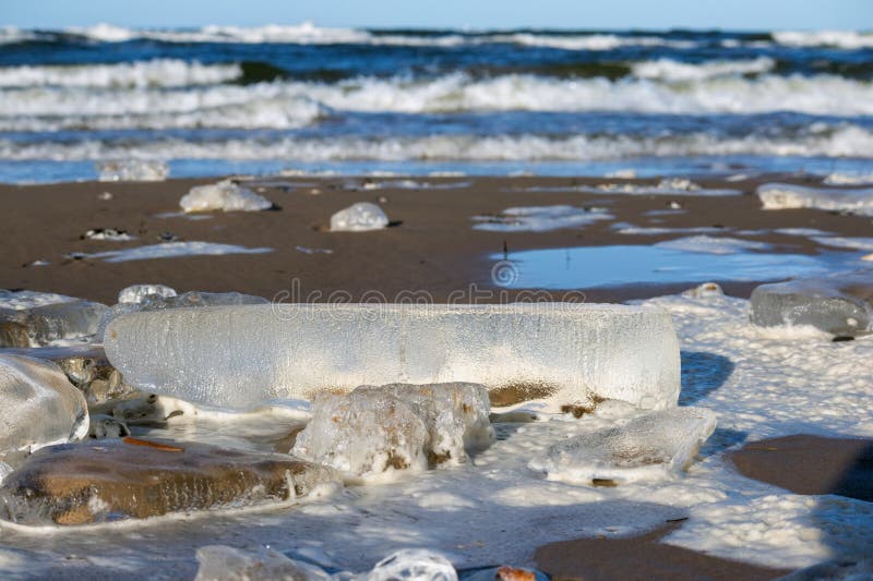 .chunks of Ice on a Sandy Beach with the Sea in the Background Stock ...