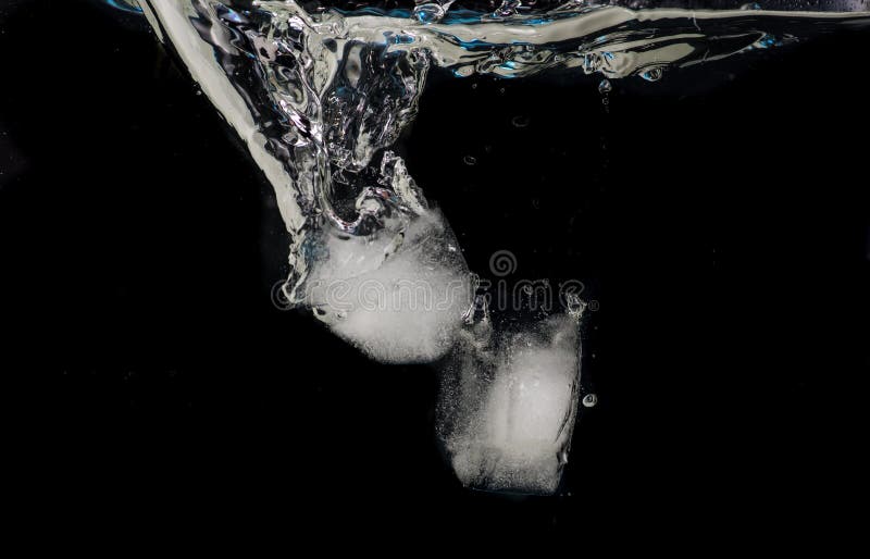 Chunks of Ice Thrown into Water on a Black Background Stock Photo ...