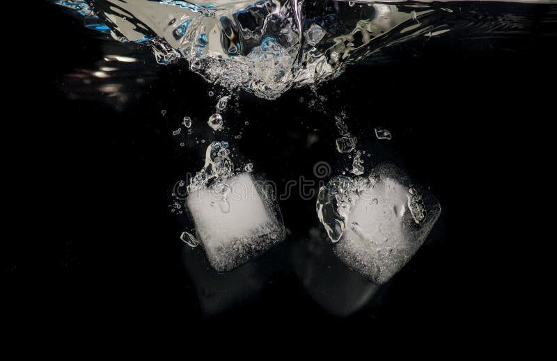Chunks of Ice Thrown into Water on a Black Background Stock Image ...