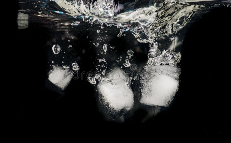 Chunks of Ice Thrown into Water on a Black Background Stock Image ...