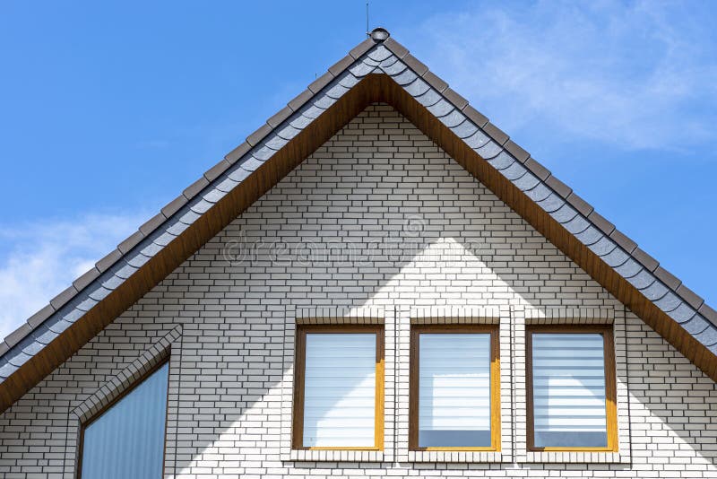 The Church Has a Classic Facade of White Brick and a Conical Roof ...