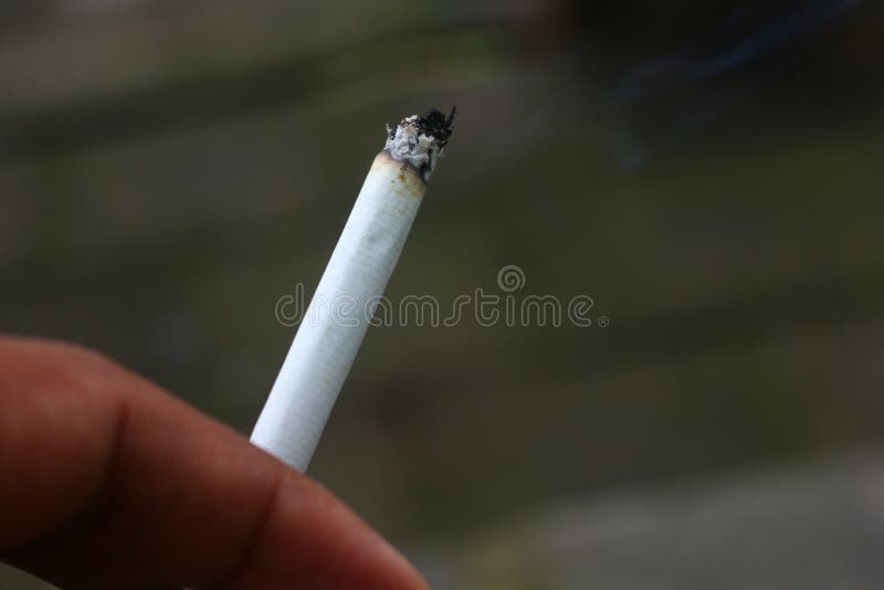 A Cigarette that is Being Lit Has a Red Flame Stock Image - Image of ...