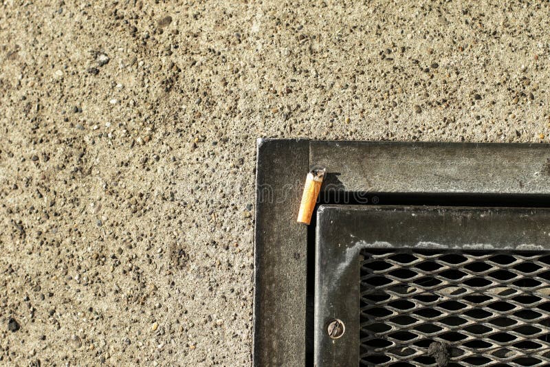 Cigarette End on the Pavement. Discarded Cigarette on the Ground ...