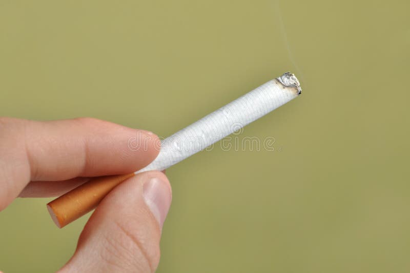 Cigarette in hand stock image. Image of risk, tobacco - 14380217