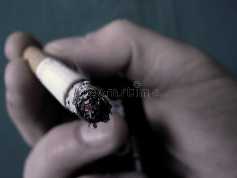 A cigarette is in a hand stock image. Image of green, palm - 6688595