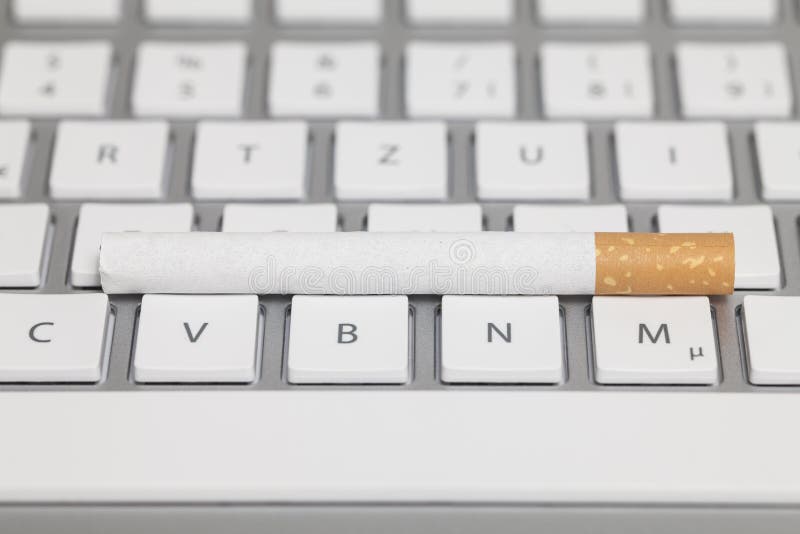 Cigarette on keyboard stock photo. Image of smoke, smoking - 65371322