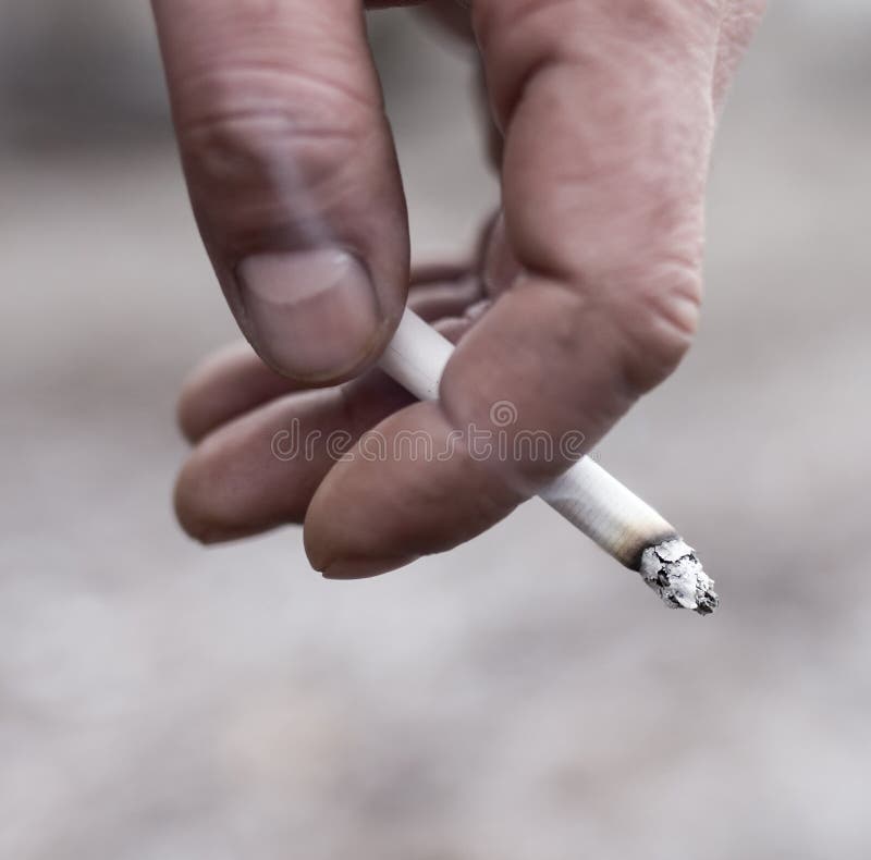 A cigarette in man hand stock image. Image of finger - 25225889
