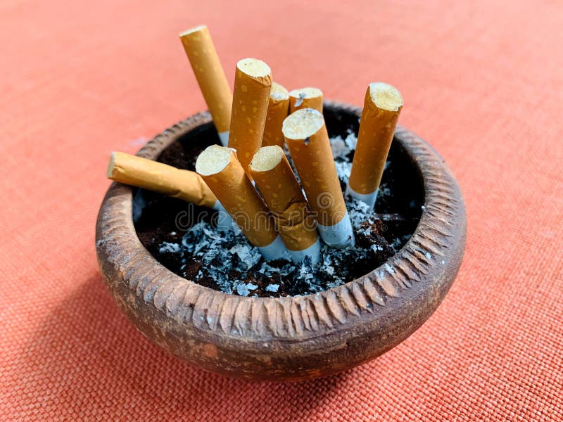 Cigarette Put Inside of Baked Clay Pot on Orange Table Stock Image ...