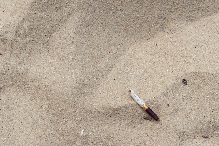 Cigarette on the sand stock image. Image of unhealthy - 142842957