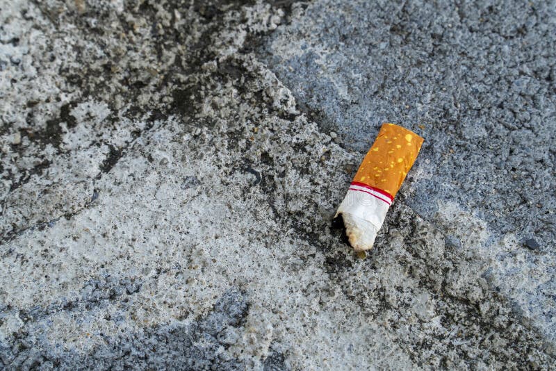 Cigarette Stub of White on Black Cement Stock Image - Image of nicotine ...
