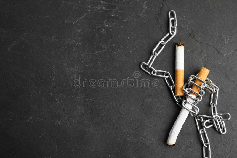 Cigarette Stubs and Chain on Black Table, Flat Lay with Space for Text ...