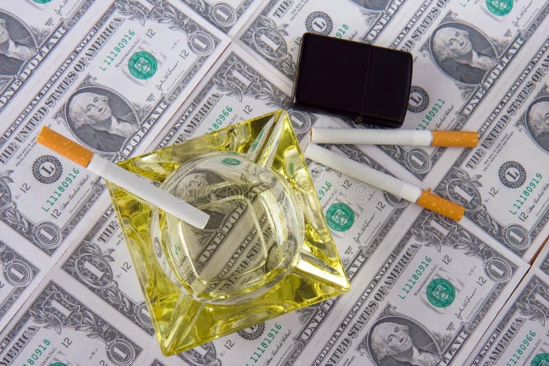Cigarettes laying on money stock photo. Image of cost - 8194038