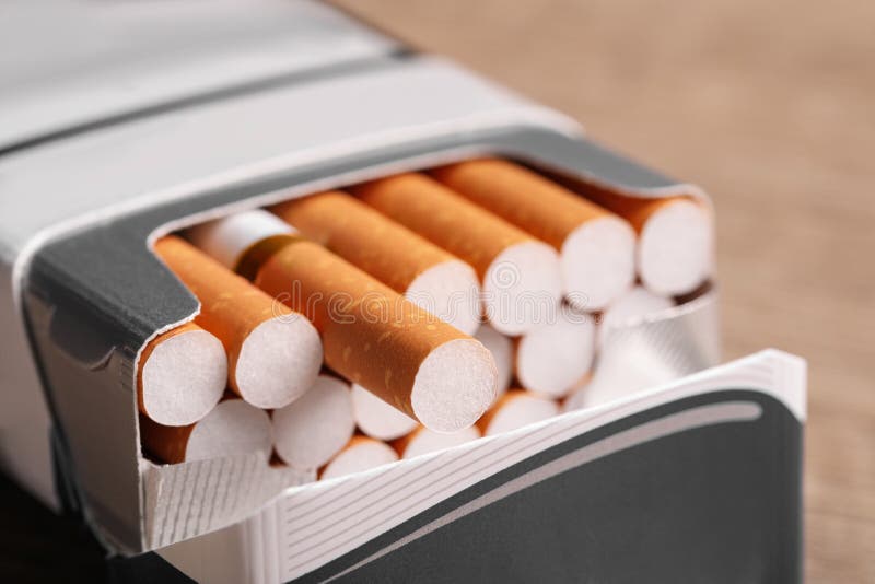 Cigarettes with Orange Filters in Pack on Table, Closeup Stock Image ...