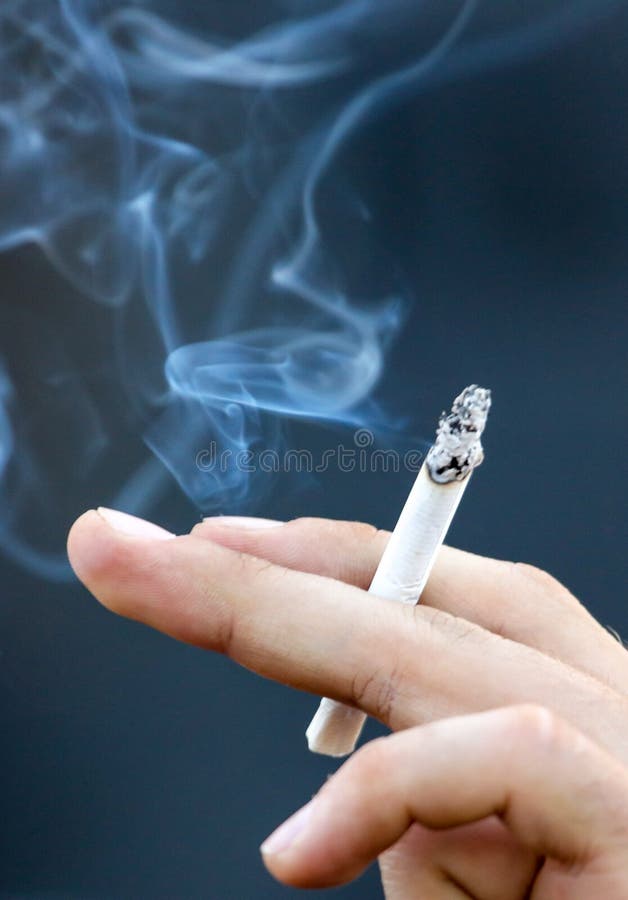 Cigarettes are Smoking in the Hand of a Man Stock Photo - Image of ...