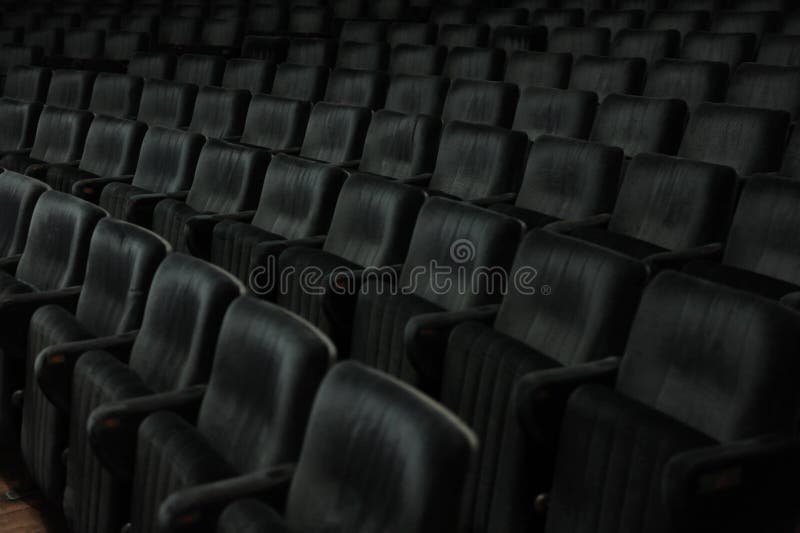 Red seats in dark cinema stock image. Image of presentation - 34961595