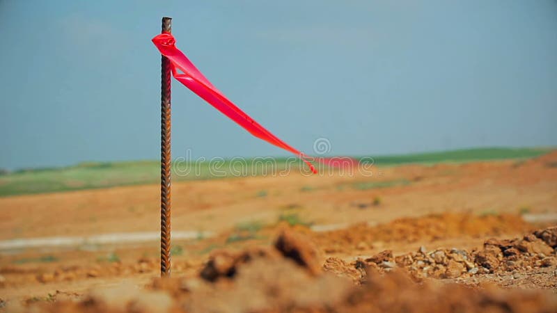 Cinemagraph of Metal Survey Peg with Red Flag on Construction Site ...