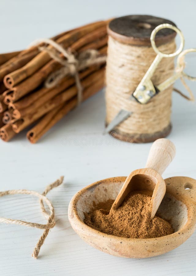 Cinnamon Powder with a Bundle of Cinnamon Sticks and a Spool of Twine ...