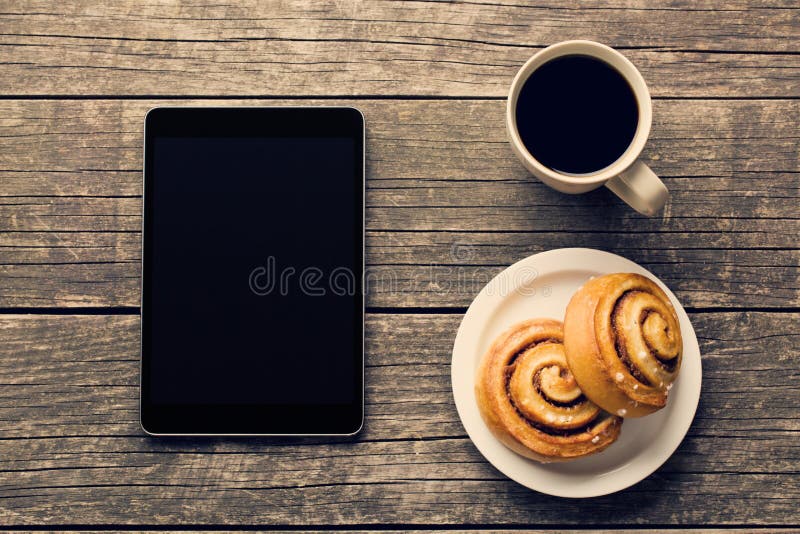 Cinnamon Rolls, Cup of Coffee and Computer Tablet Stock Photo - Image ...