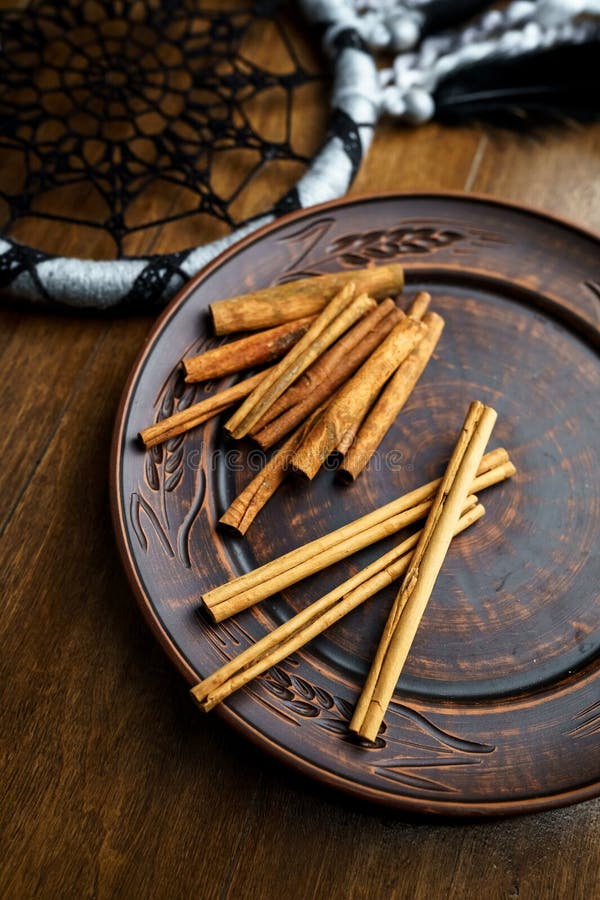 Cinnamon Sticks on a Clay Plate Vertically Close Up Stock Illustration ...