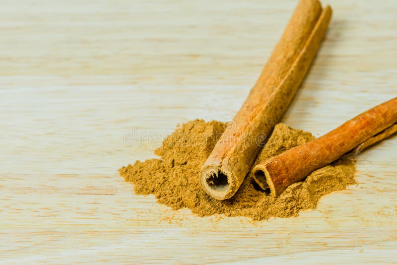 Cinnamon Sticks Laying on Cinnamon Powder Stock Photo - Image of macro ...
