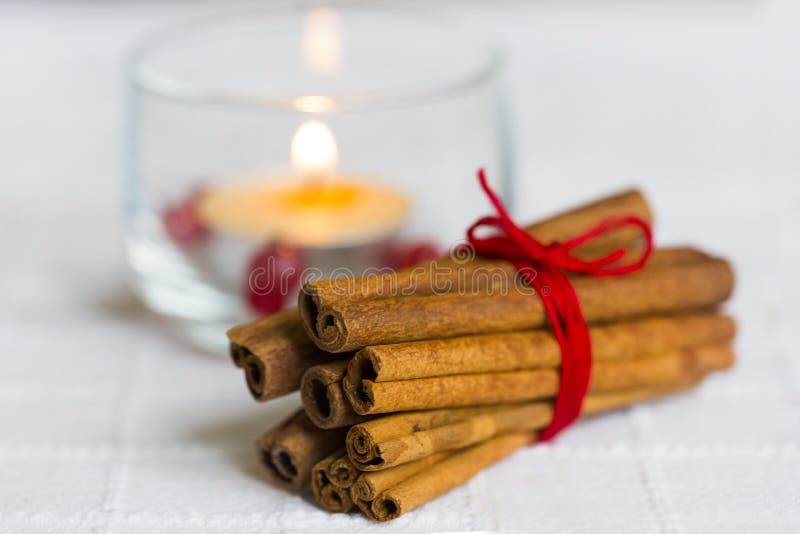 Cinnamon Sticks with Red String and Burning Candle Stock Photo - Image ...