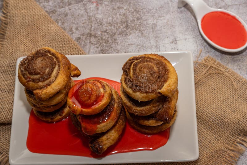 Cinnamon and Sugar Rolls Covered with Strawberry Syrup Stock Photo ...