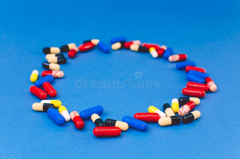 Circle of Colored Tablets on a Blue Background Stock Image - Image of ...