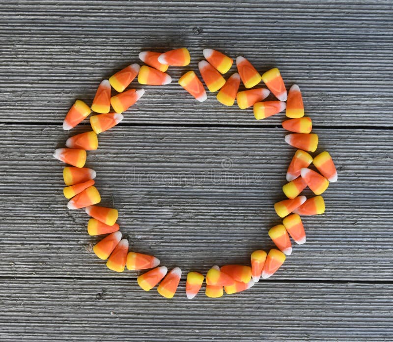 Circle Frame of Bright Candy Corn on Wood Texture Background with ...