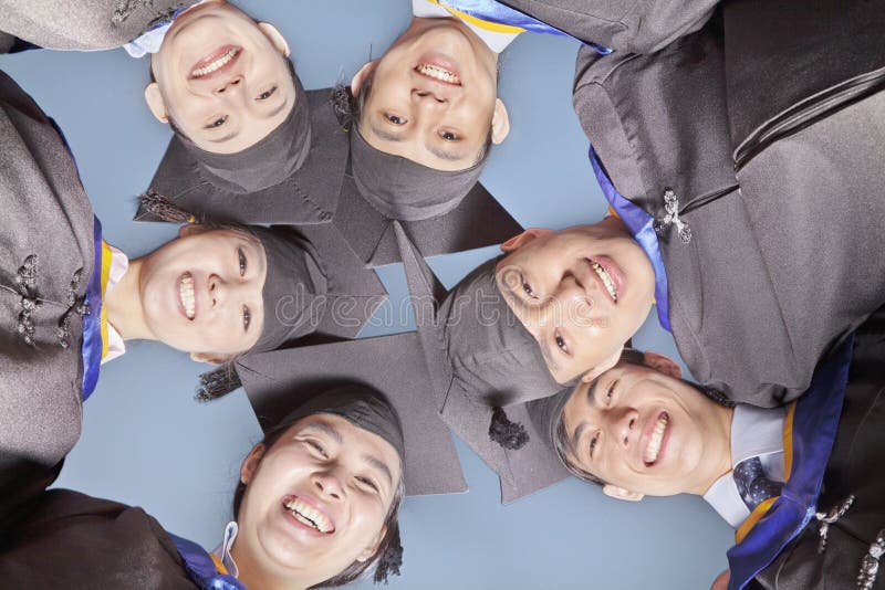 Circle of Smiling Graduate Students in Graduation Gowns Looking Down ...