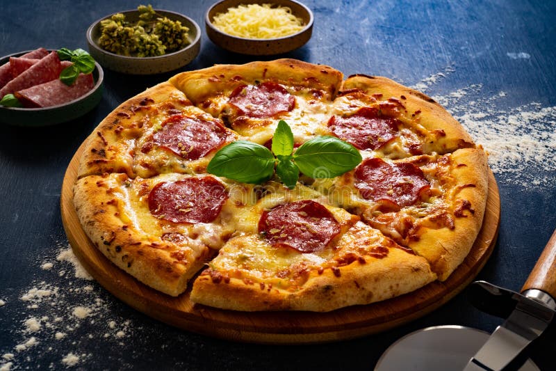 Circle Pepperoni Pizza with Mozzarella Cheese on Black Wooden Table ...